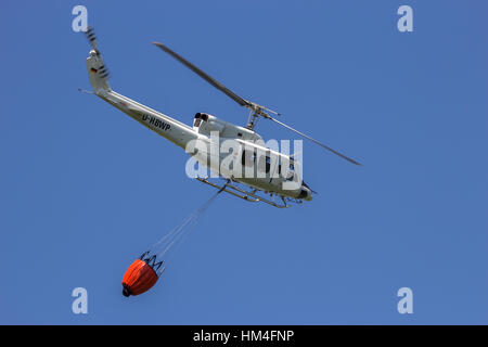 AHLEN, GERMANY - JUN 5, 2016: Bell 212 Helicopter with a bambi bucket ...