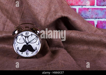Alarm clock with a comedy black hipster mustache Stock Photo - Alamy