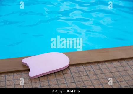 Pink boogie board in swimming pool Stock Photo - Alamy