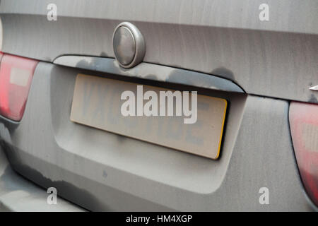 A dirty partially obscure / obscured registration number plate on a car ...