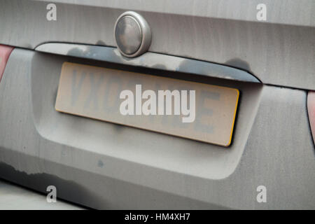 A dirty partially obscure / obscured registration number plate on a car ...