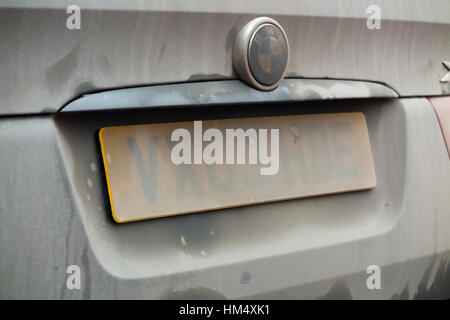 A dirty partially obscure / obscured registration number plate on a car ...
