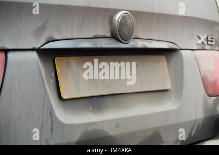 A dirty partially obscure / obscured registration number plate on a car ...