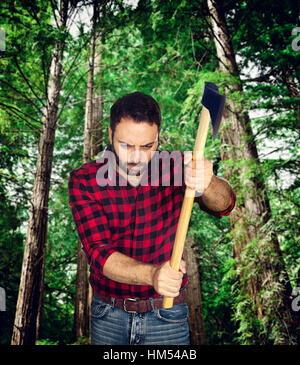 Handsome and muscular lumberjack man with an axe, camping. Man with axe ...