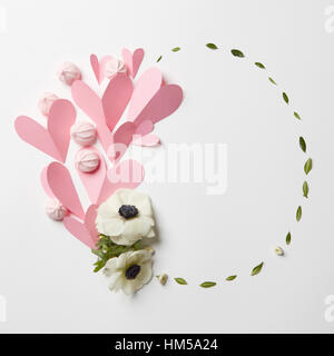Round frame of craft paper hearts and circles on wooden background ...