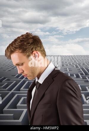 Businessman standing against difficult maze puzzle Stock Photo - Alamy
