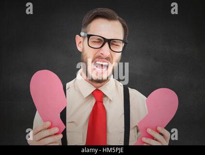 Crying man holding broken heart Stock Photo - Alamy