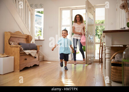 Excited Children Returning Home From School With Mother Stock Photo - Alamy