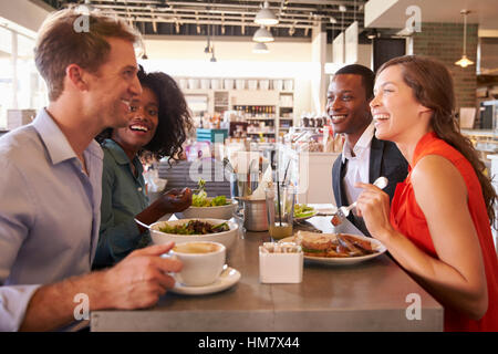 Group Enjoying Business Lunch At Delicatessen Counter Stock Photo - Alamy