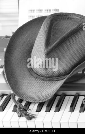 Cowboy hat on top of piano keyboard Stock Photo - Alamy