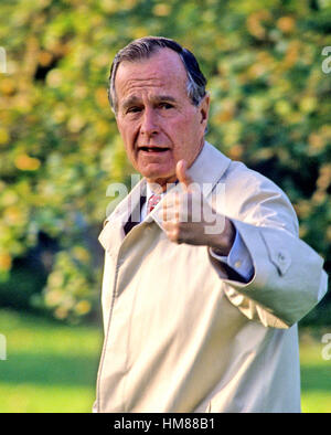 President George W. Bush gives a thumbs-up as he stands on the mound at ...
