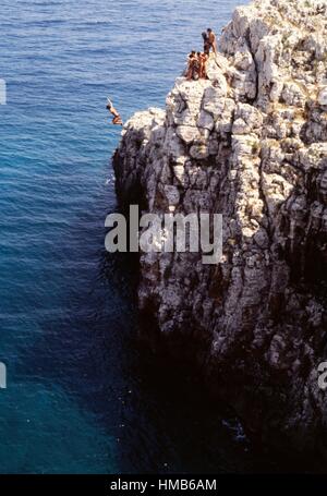 Boys diving off a cliff near Santa Maria di Leuca, Apulia, Italy Stock ...