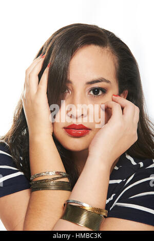 Young hispanic woman with red hair standing over pink background ...