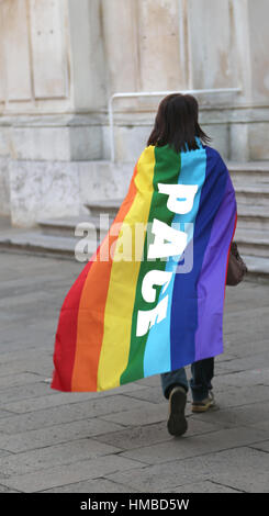 A rainbow flag with the Italian word "Pace" meaning "Peace" written on ...