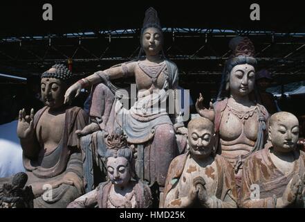 Religious-themed statues, Panjiayuan market, Beijing, China Stock Photo ...