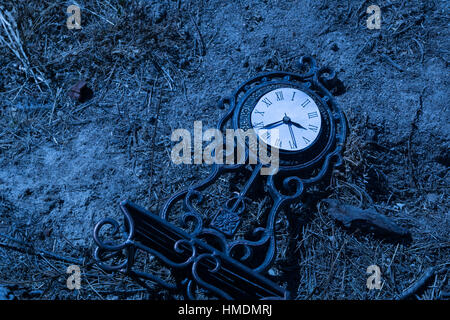 An old clock in the dirt Stock Photo - Alamy