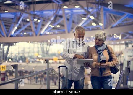 Senior couple traveling airport scene Stock Photo - Alamy