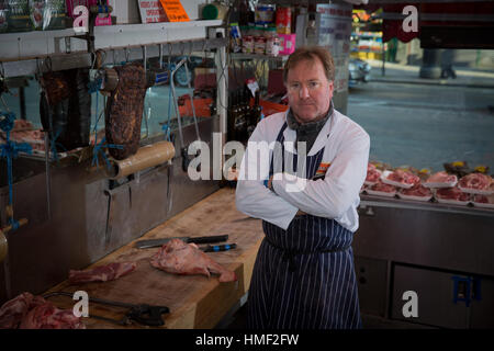 Butchers pose outside their butcher shop in London Stock Photo - Alamy