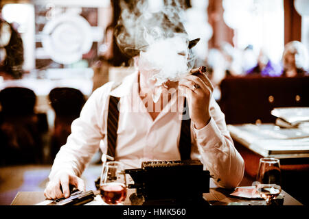 Mobsters sitting and smoking a cigar through smoke Stock Photo - Alamy