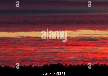 Vibrant fiery red sunset clouds sky background Stock Photo - Alamy