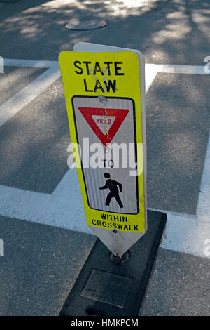 State Law Pedestrian Crosswalk Sign on a busy street in a neighborhood ...