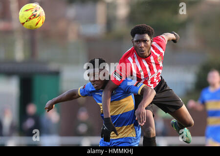 Tobi Coker of Hornchurch tangles with Ayodeji Olukoga of Romford during ...