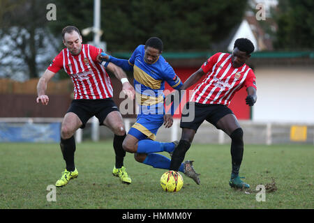 Tobi Coker of Hornchurch tangles with Ayodeji Olukoga of Romford during ...