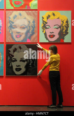 Project curator Catherine Daunt checks 10 "Marilyn" screenprints by ...