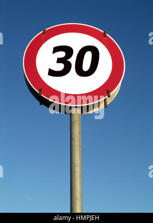 30km per hour road speed sign and orange traffic cones on the street ...