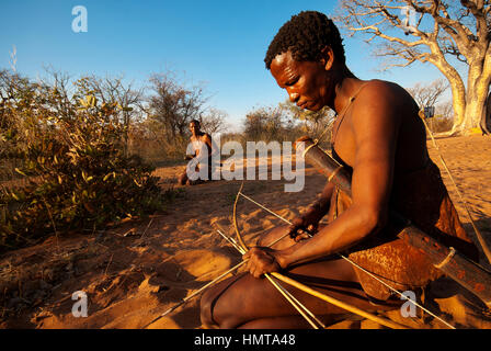 Ju/'Hoansi or San bushmen hunter simulates a hunt with bow and arrow at ...