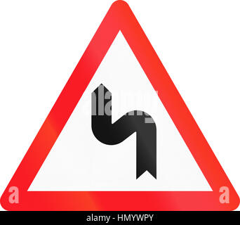 Double bend first to left road sign on white background Stock Photo - Alamy