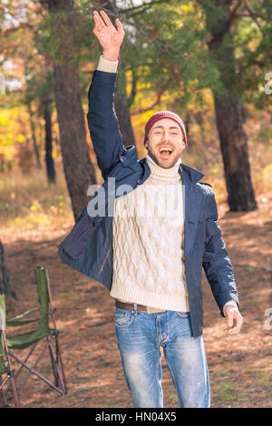 Smiling man waving with hand Stock Photo - Alamy