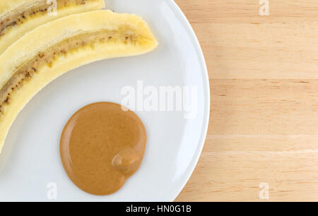 A top view of a Peanut Butter Banana Toast on white table Stock Photo ...