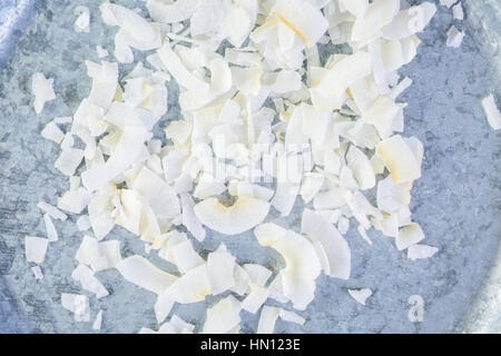 Dehydrated coconut flakes on a metal background Stock Photo - Alamy