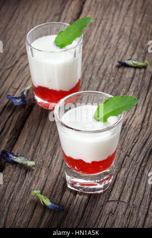 fresh natural yogurt with strawberry jam in glass on wooden plank Stock ...
