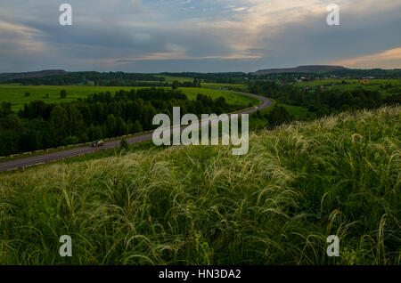 Summer crimson sunset. sky crimson. maroon clouds on sunset. green ...