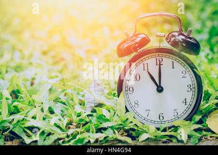 Analog alarm clock showing eleven o'clock, 11pm or 11am isolated on ...