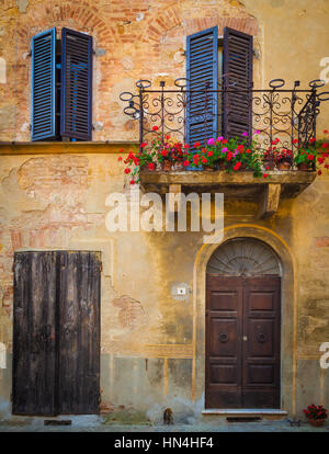 Italy, Tuscany, Pienza. Flower pots and potted plants decorate a narrow ...