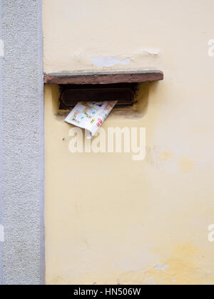 Junk mail and advertising on houses letter boxes Stock Photo - Alamy