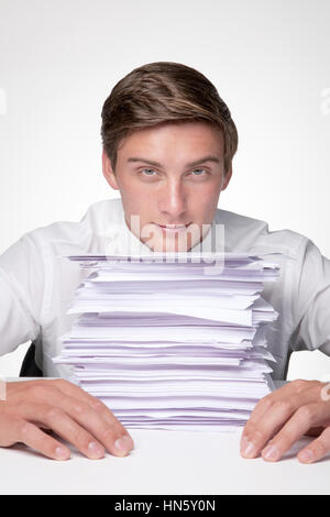 The overloaded busy employee with too much work and paperwork Stock ...