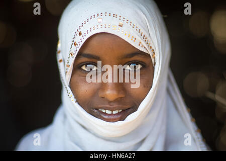 Portrait of a veiled smiling afar tribe girl with sharpened teeth, Afar ...