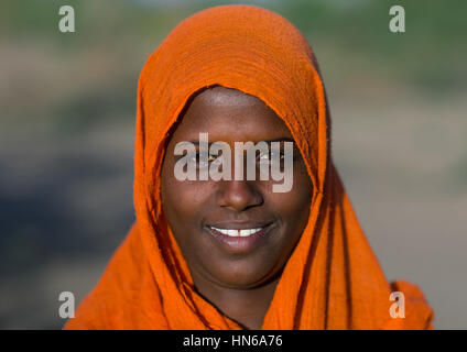 Portrait of a veiled smiling afar tribe girl with sharpened teeth, Afar ...