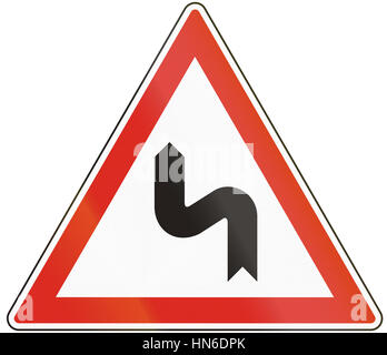 Double bend first to left road sign on white background Stock Photo - Alamy