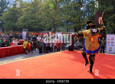 Hefei, China. 9th Feb, 2017. An actor performs face changing at a ...