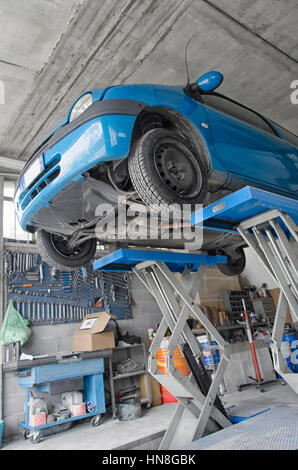 Car is raised on a lift to replace the crankshaft Stock Photo - Alamy