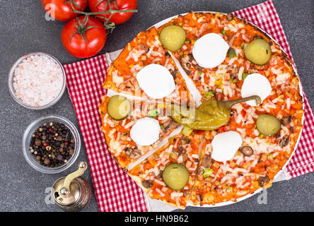 Home pizza with mozzarella and pickled gherkins Stock Photo - Alamy