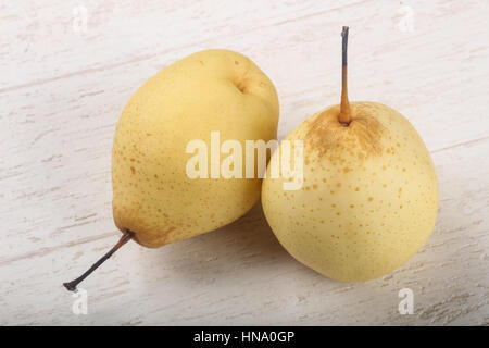 Sweet Chinese pear over the wooden background Stock Photo - Alamy