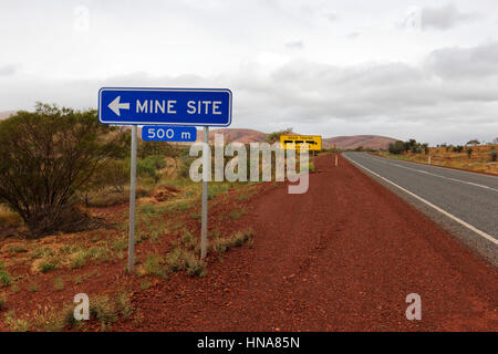 Roadside mine site and road train signs with passing truck, Pilbara ...