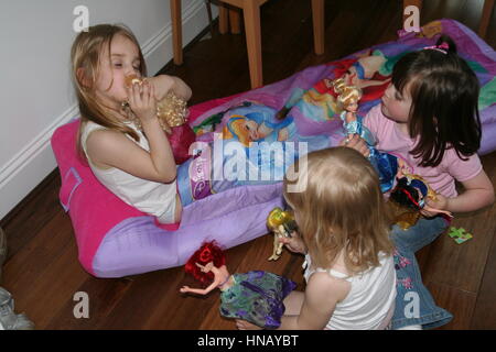 little girl playing with her barbie dolls Stock Photo - Alamy