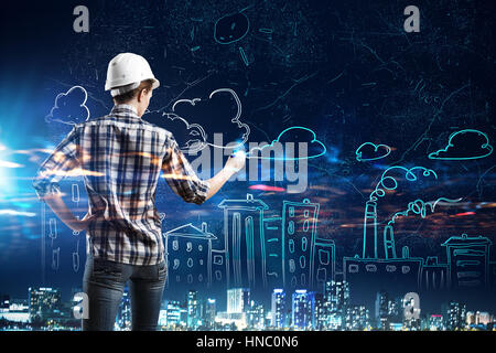 Rear view of engineer woman drawing construction plan Stock Photo - Alamy